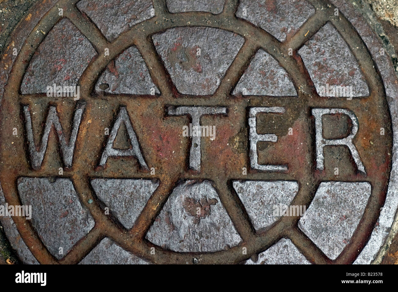 Close up of manhole cover for water main pipe Stock Photo - Alamy