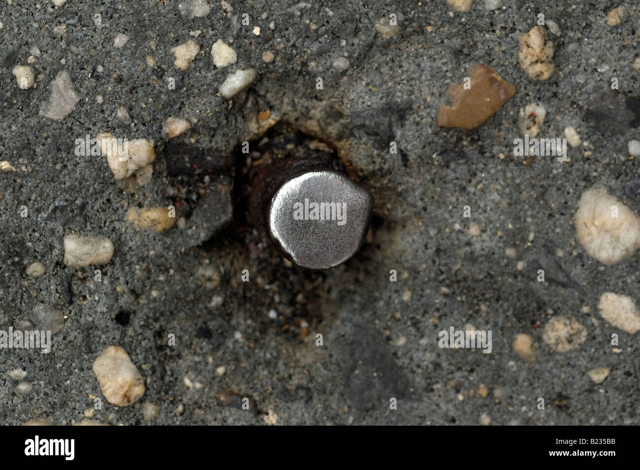 Close up of a silver colored bolt in the street Stock Photo - Alamy