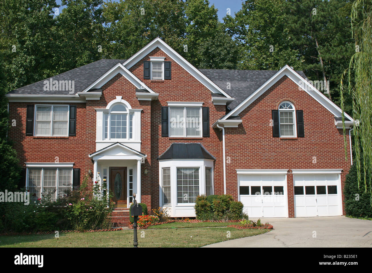 A nice brick house against a blue sky Stock Photo - Alamy
