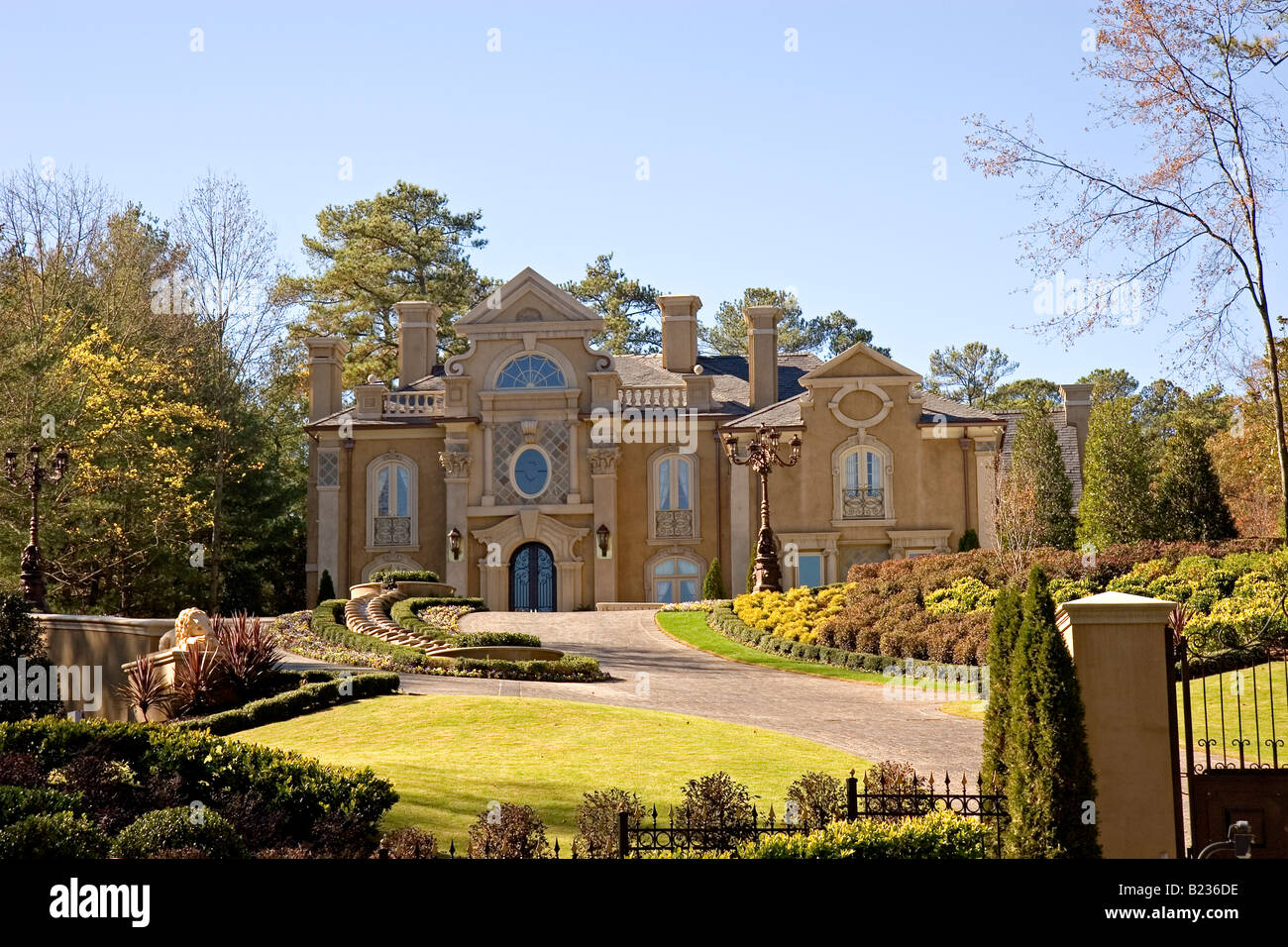 A large stucco mansion on top of a grassy hill Stock Photo - Alamy