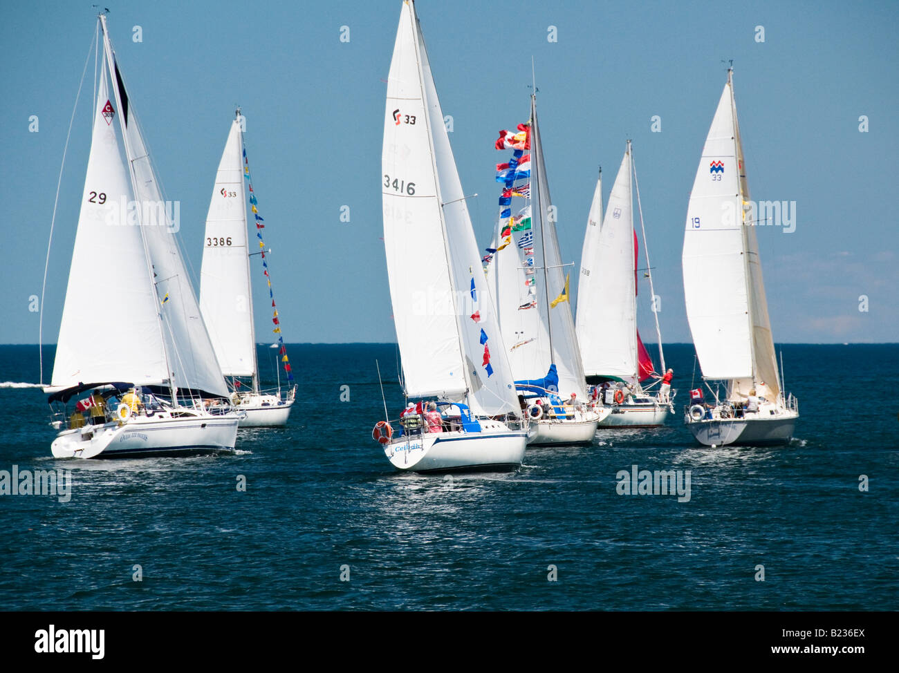 Sailboats participating in a Sail Past at the waterfront in Burlington ...