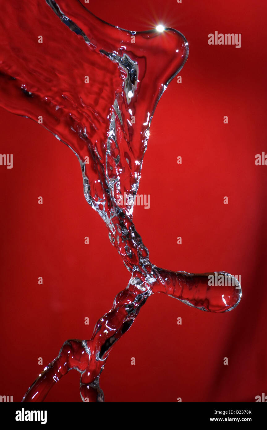 Flowing water stream over colored background Stock Photo - Alamy