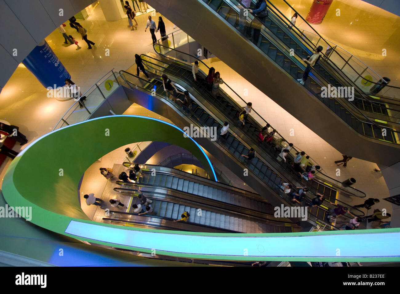 bright shopping centre lighting around a multi story escalator in ...