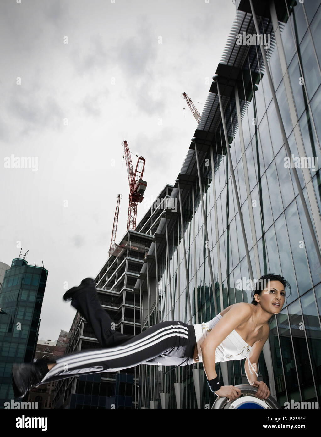 Woman Vaulting over road sign Stock Photo - Alamy