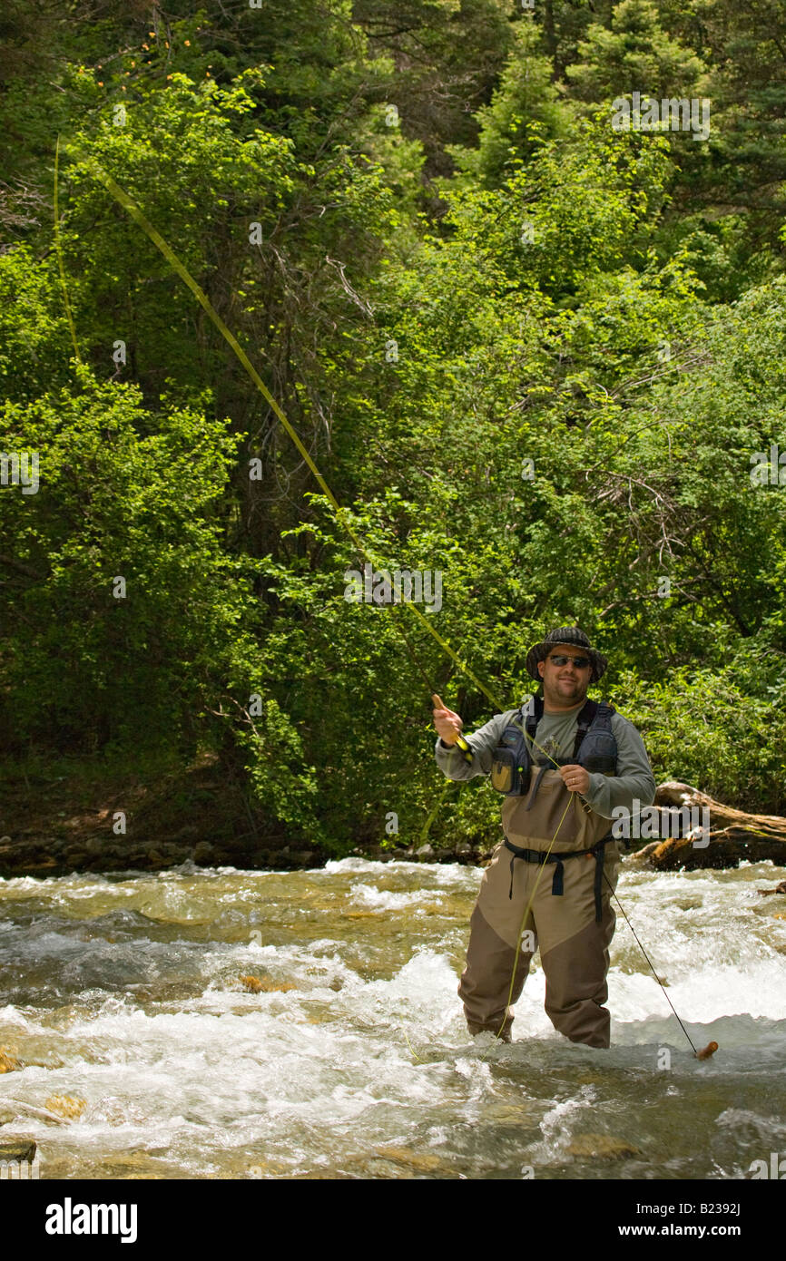 Man casting a fly fishing rod along the Rio Hondo near Taos New Mexico ...