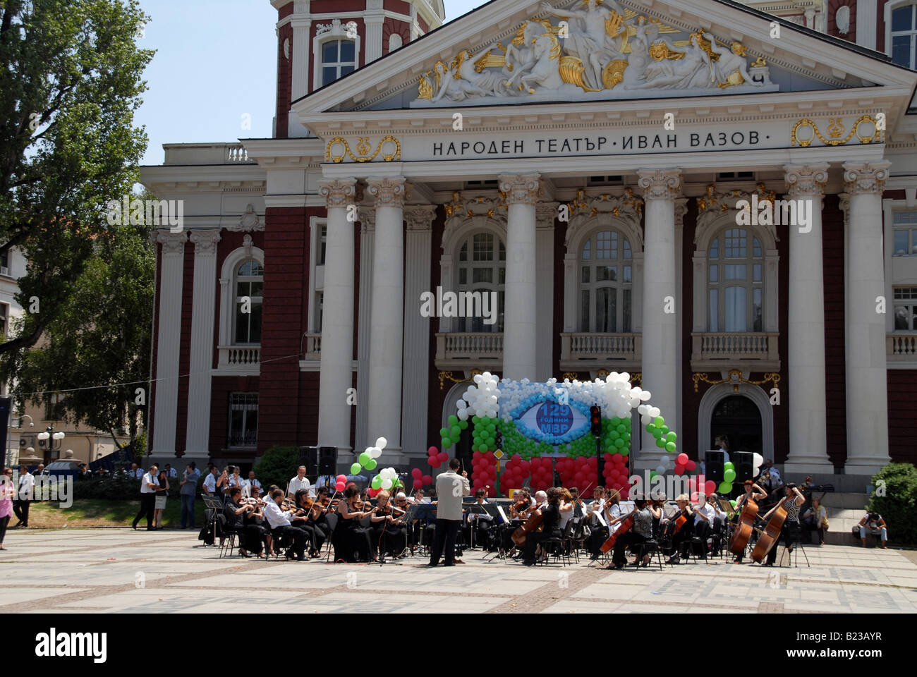 An orchestra playing outside the elegant neo-classical National Theatre ...
