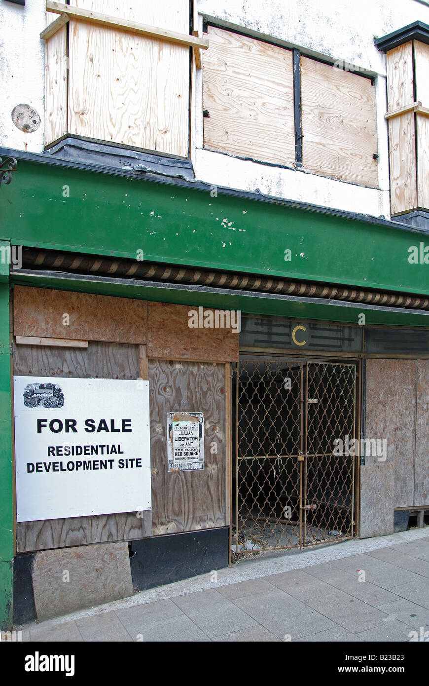 an closed down and boarded up shop in the town centre of redruth in ...