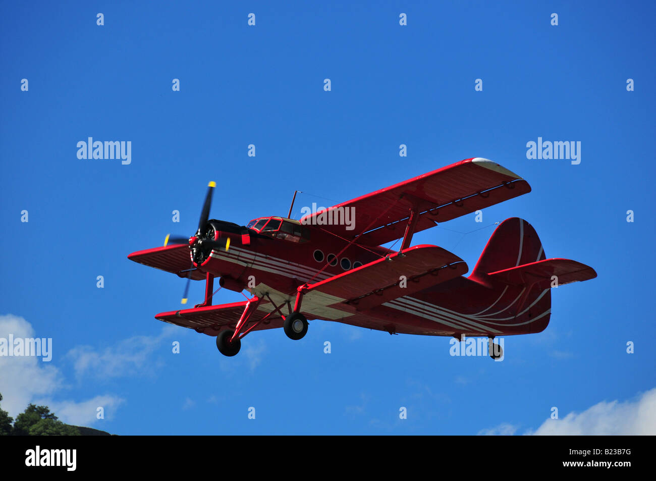 Red biplane against deep blue sky This model is an Antonov AN 2 Stock ...