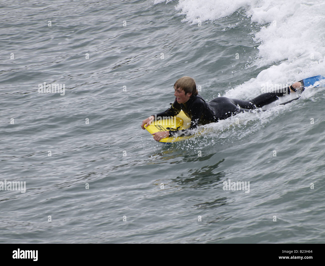 Teenage boy bodyboarding Stock Photo - Alamy