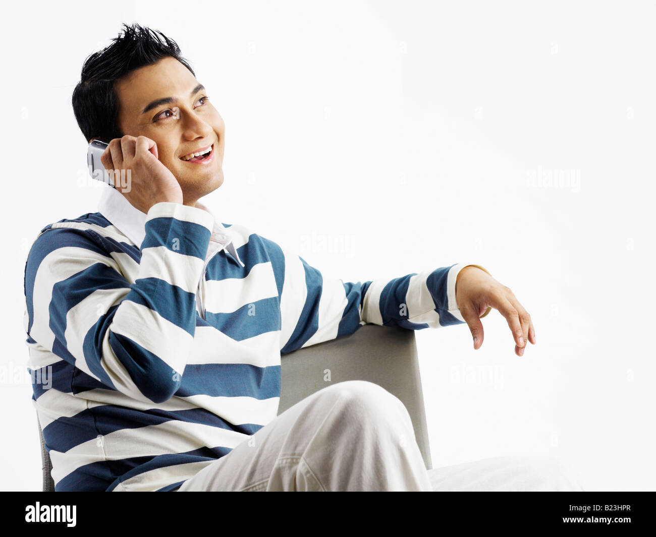man sitting alone using cellphone Stock Photo - Alamy