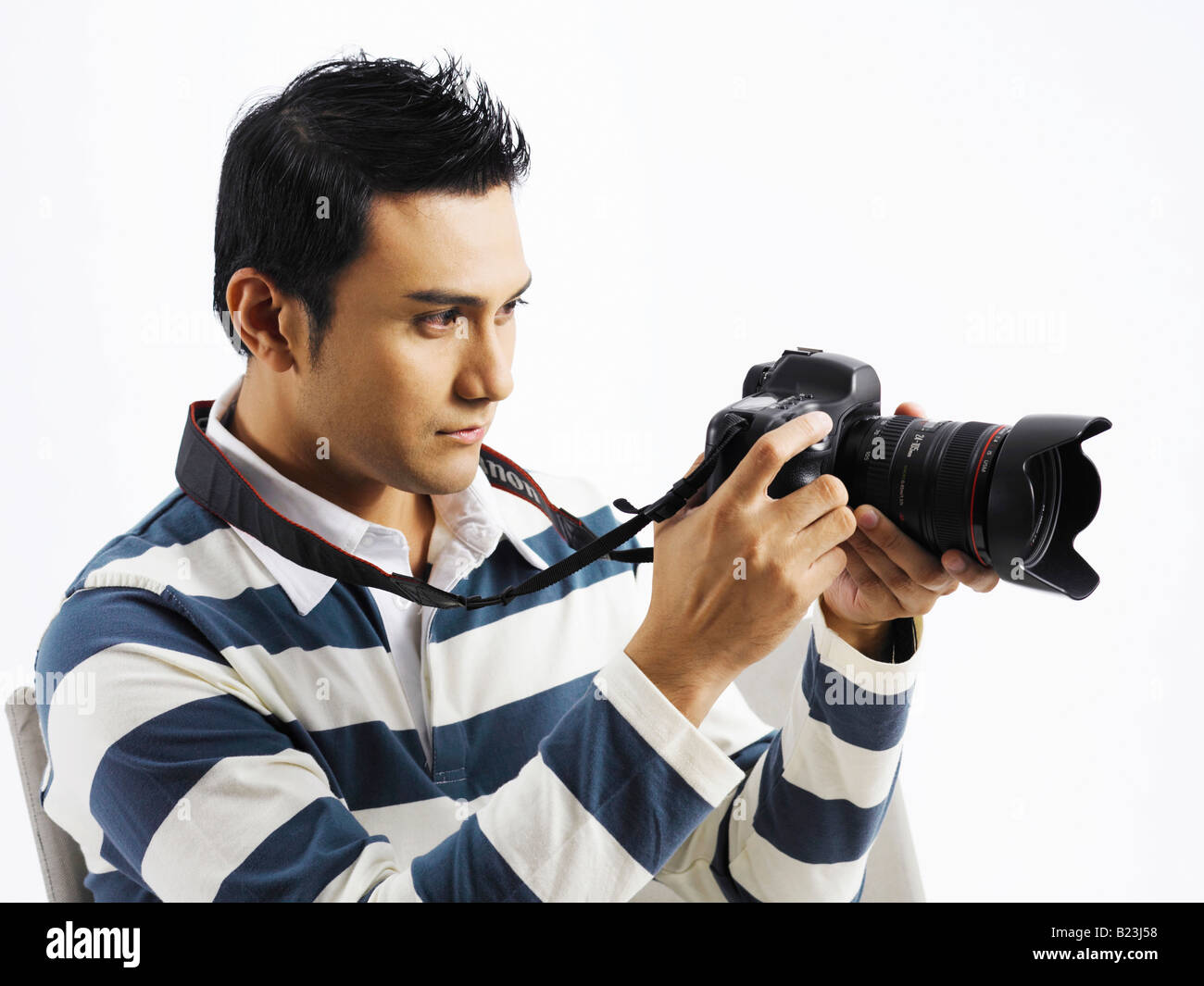 young man checking his camera Stock Photo - Alamy