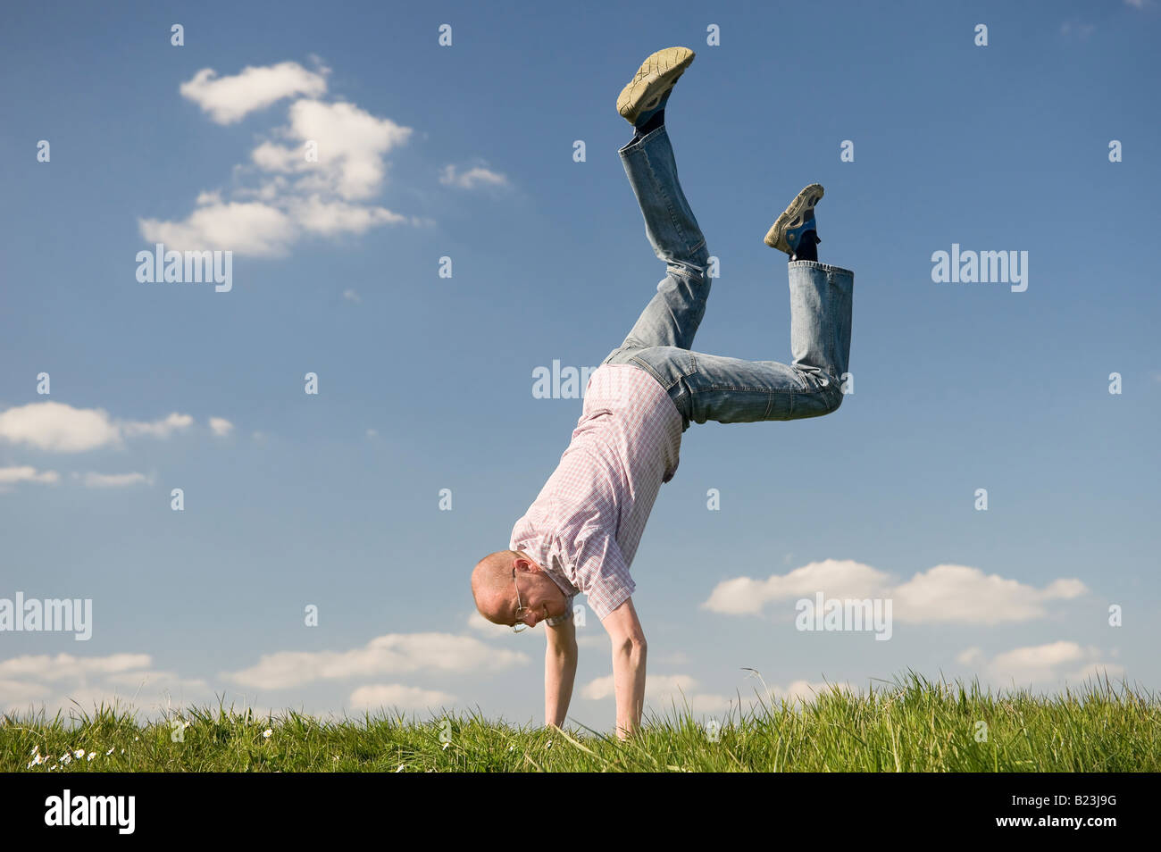 Young man is turning a cartwheel Lifestyle picture Stock Photo - Alamy