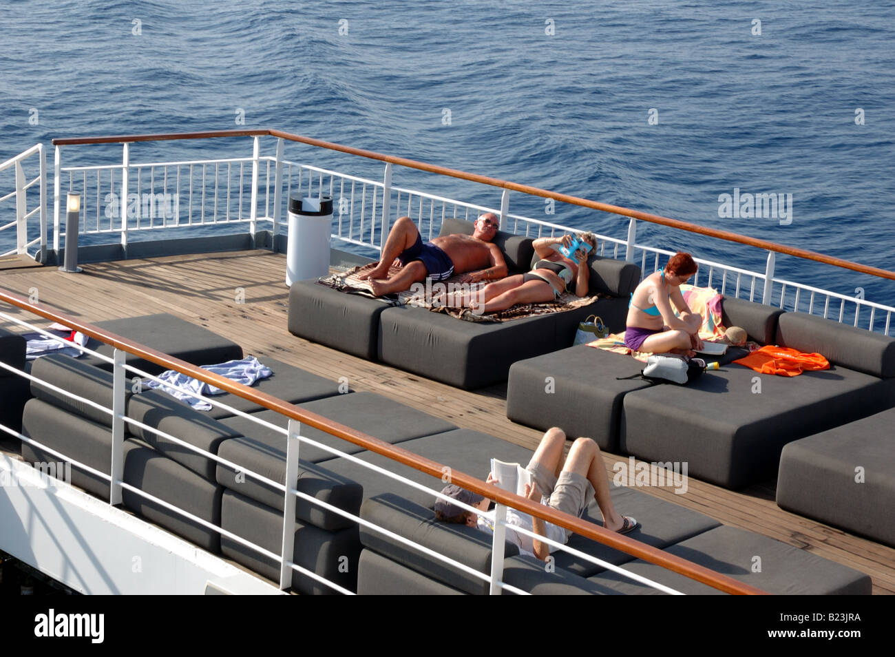 Passengers on budget cruise ship easyCruise Life relaxing on the sun ...