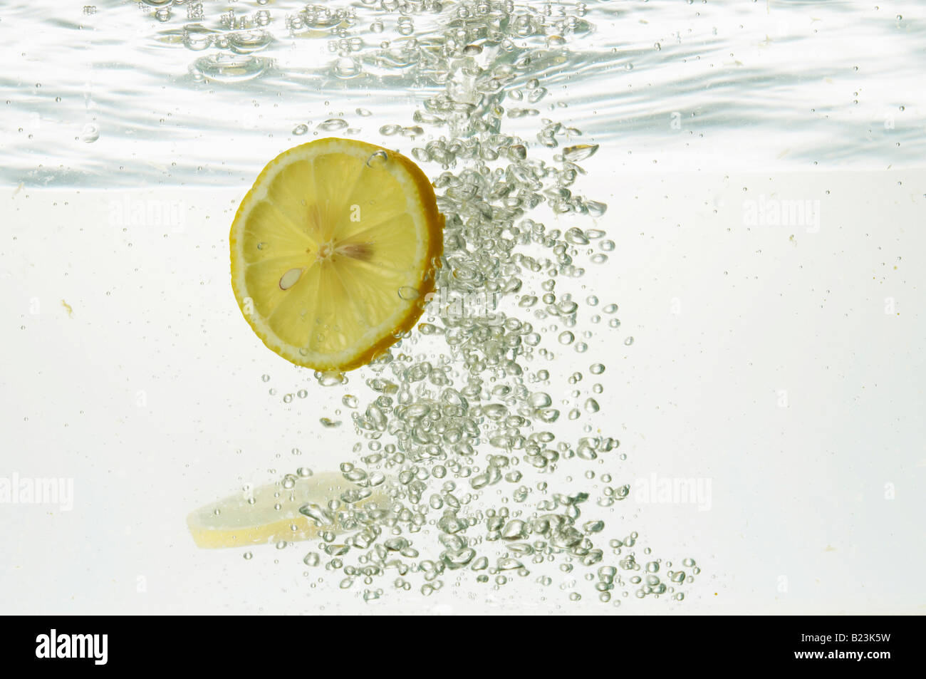 slice of lemon in water Stock Photo - Alamy