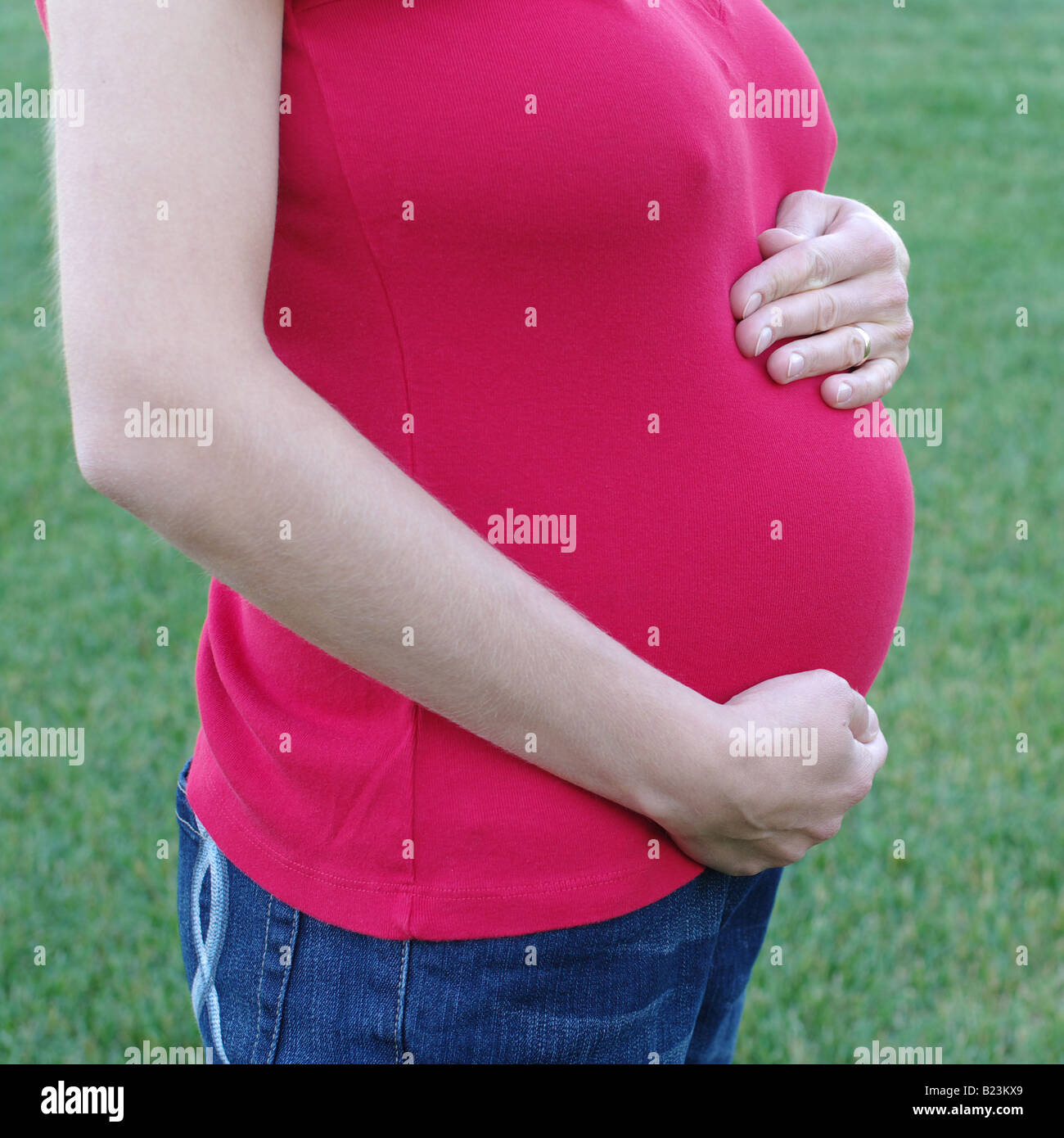 Pregnant woman bracing her womb Stock Photo - Alamy
