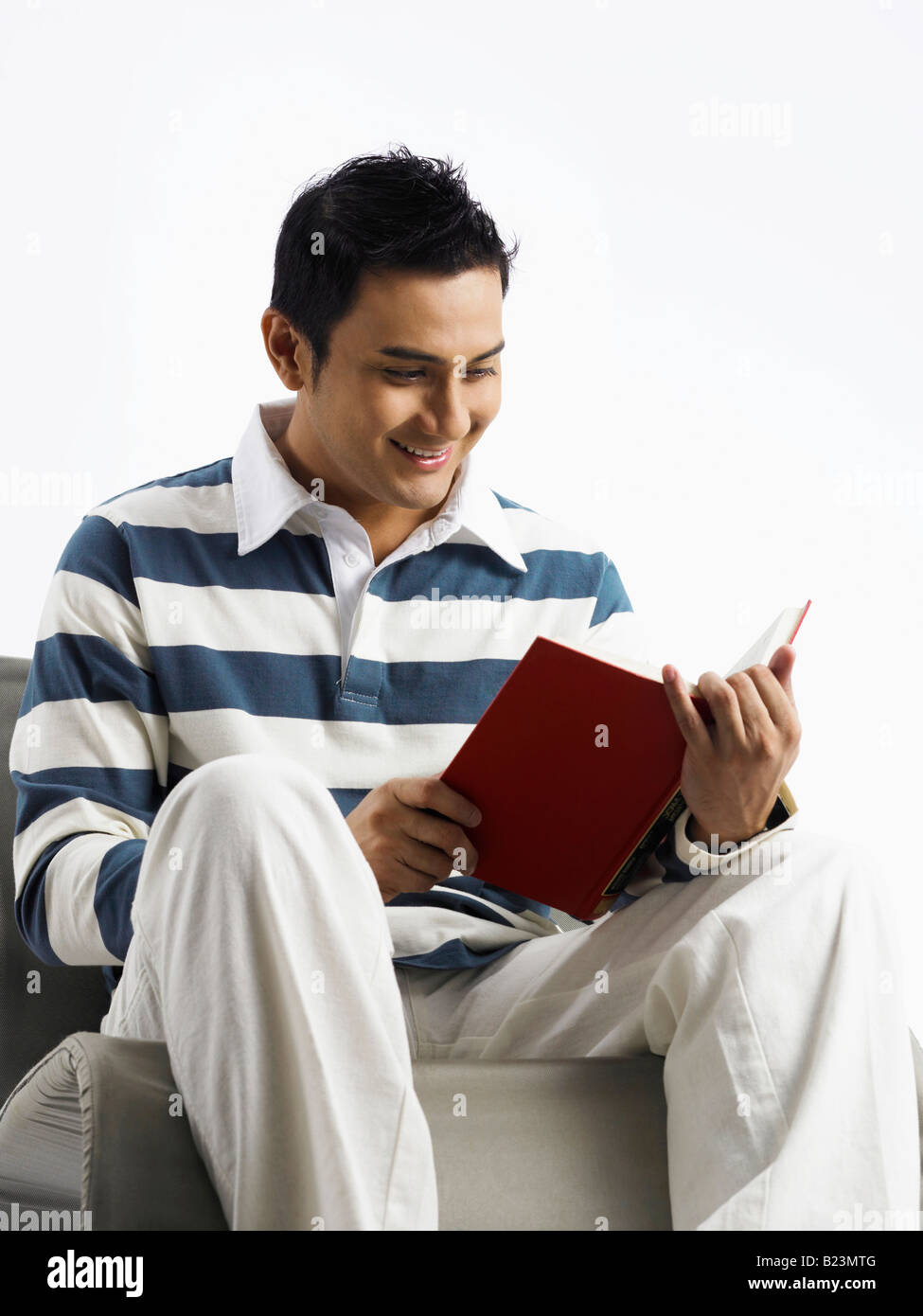 man reading an interesting book Stock Photo - Alamy
