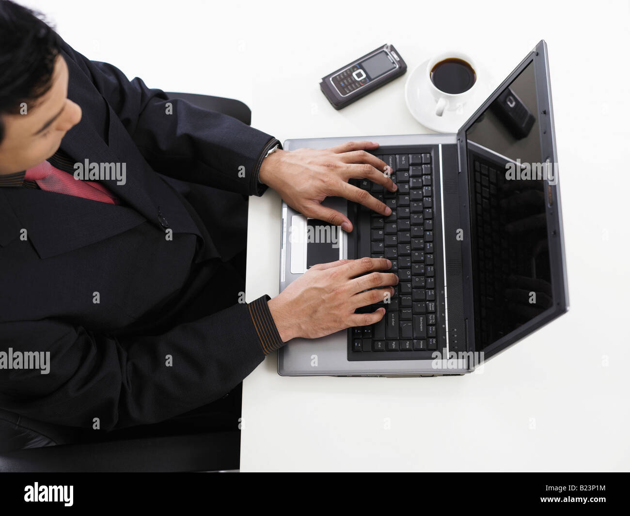 Looking down at a businessman using a laptop computer Stock Photo - Alamy
