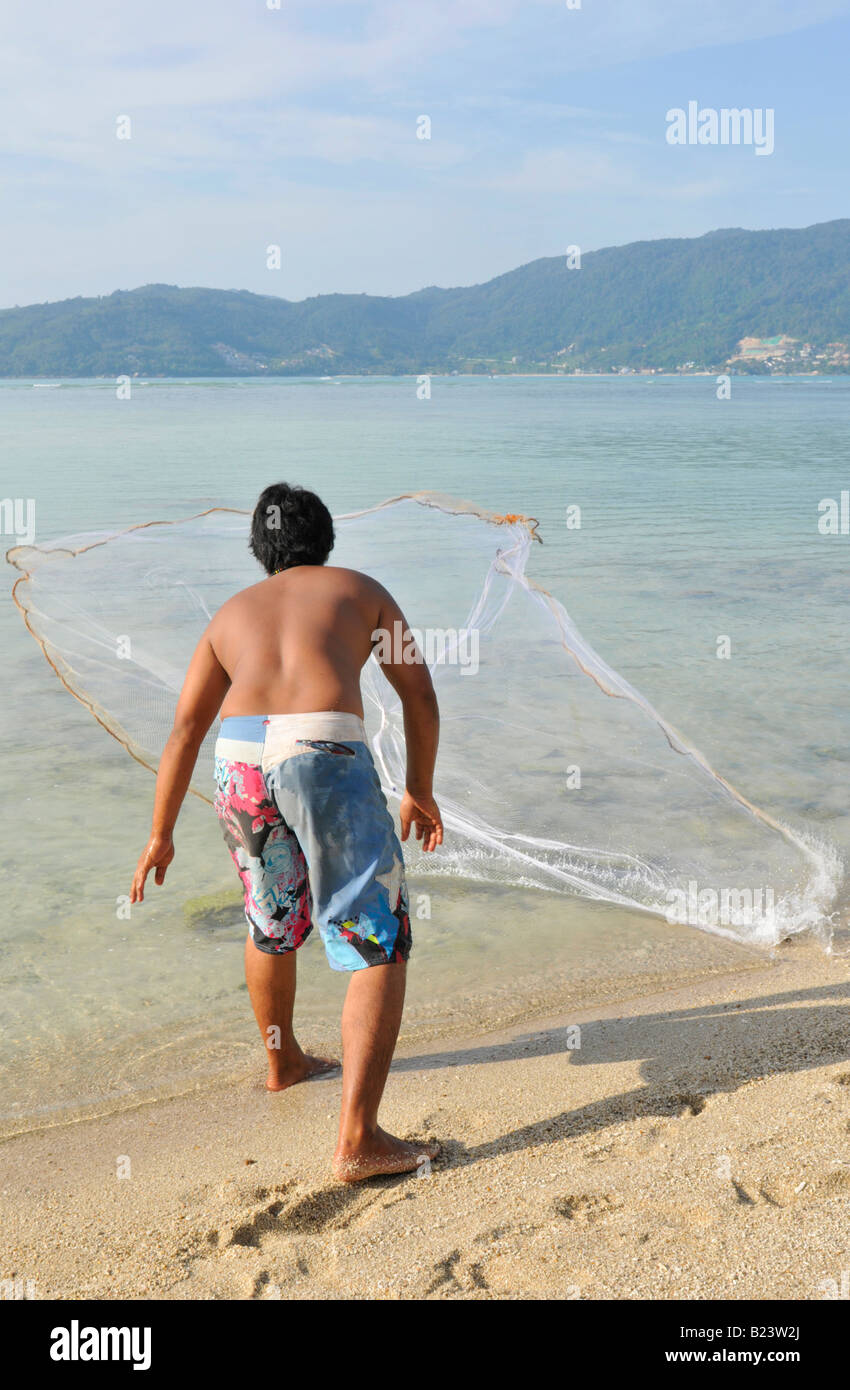 fisherman casting his net, freedom beach , phuket , thailand Stock ...