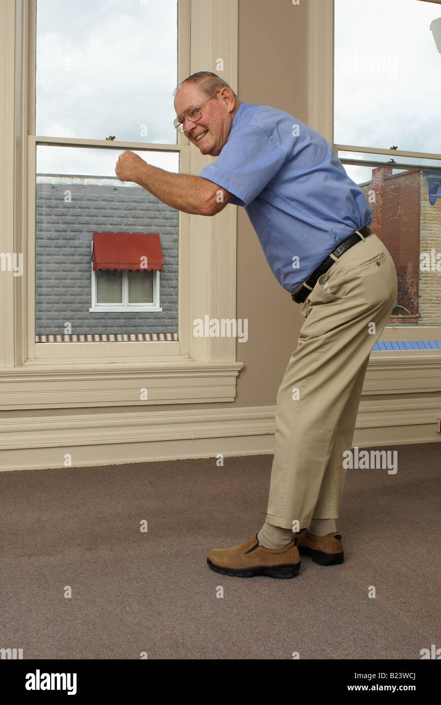 Old man showing off Stock Photo - Alamy