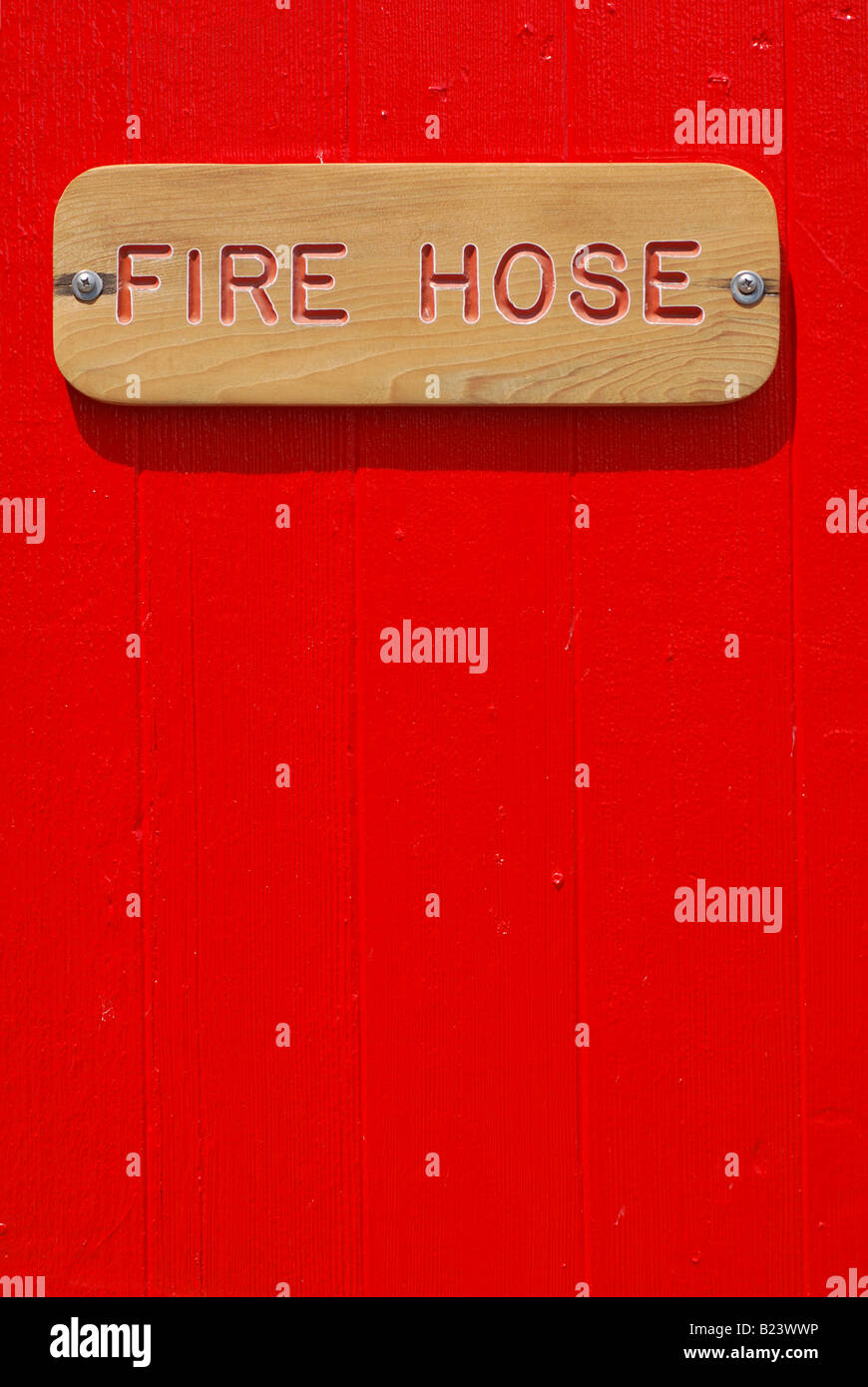 Fire Hose sign on a red painted wooden shed with copyspace Stock Photo ...