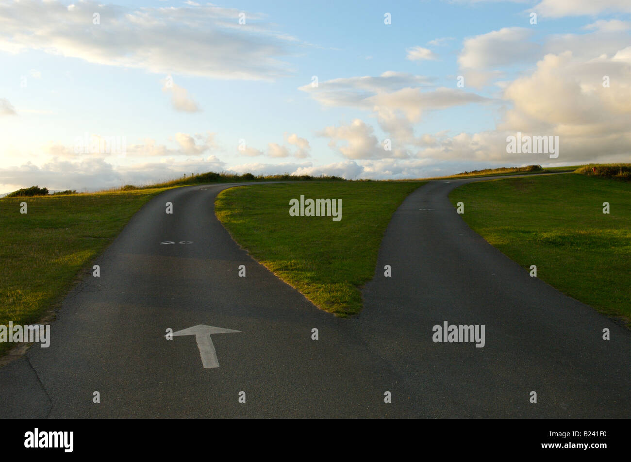 An arrow pointing the direction on a two way road Stock Photo - Alamy