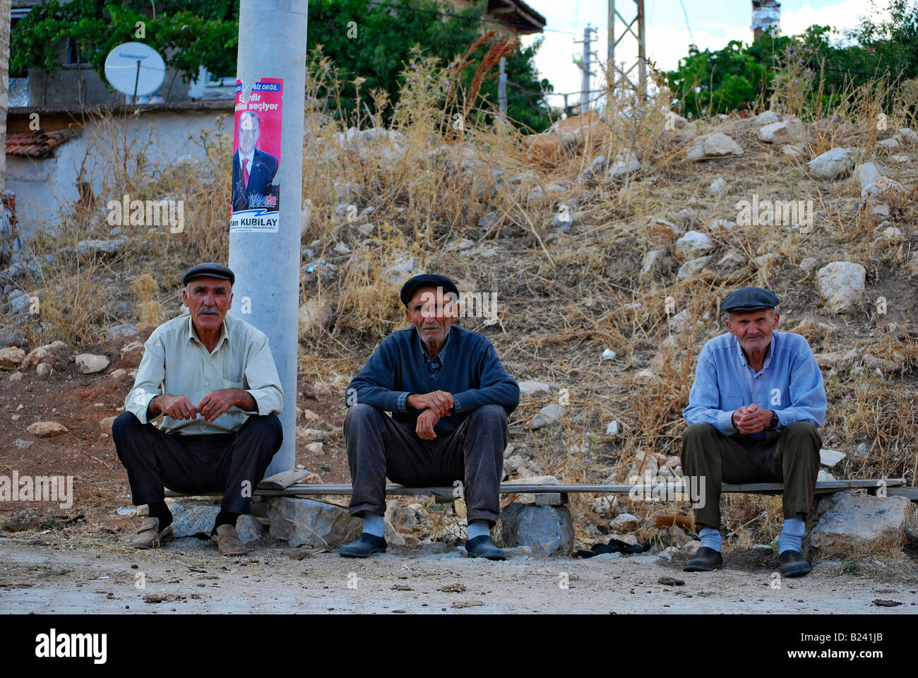 Three old men on a makeshift bench in the village of Akpinar, Anatolia ...