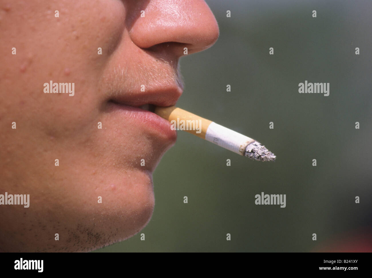 Teen boy smoking cigarette thin blond mustache mouth Stock Photo - Alamy