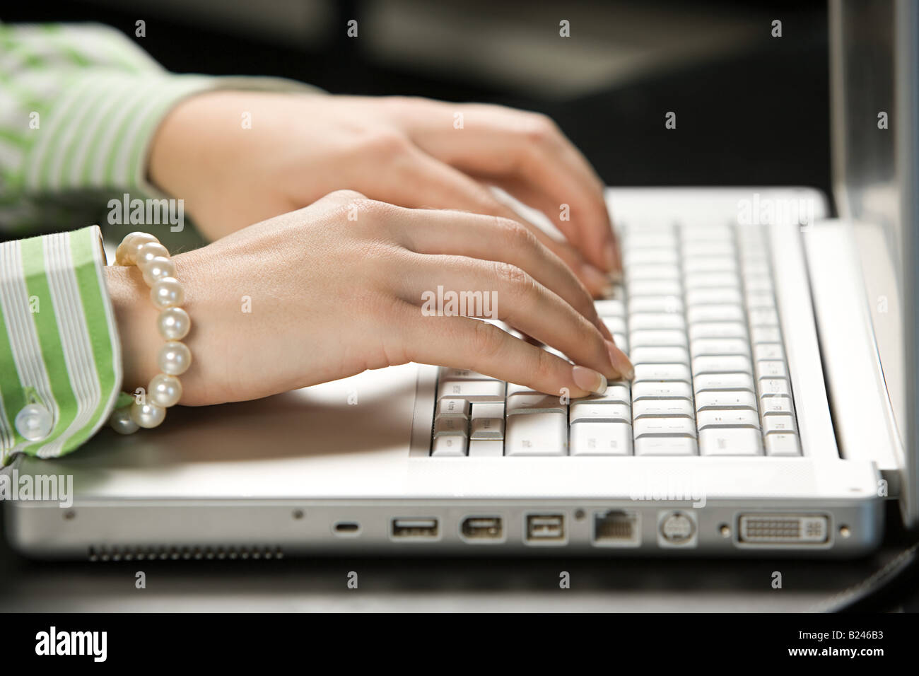 An office worker typing on a laptop Stock Photo - Alamy