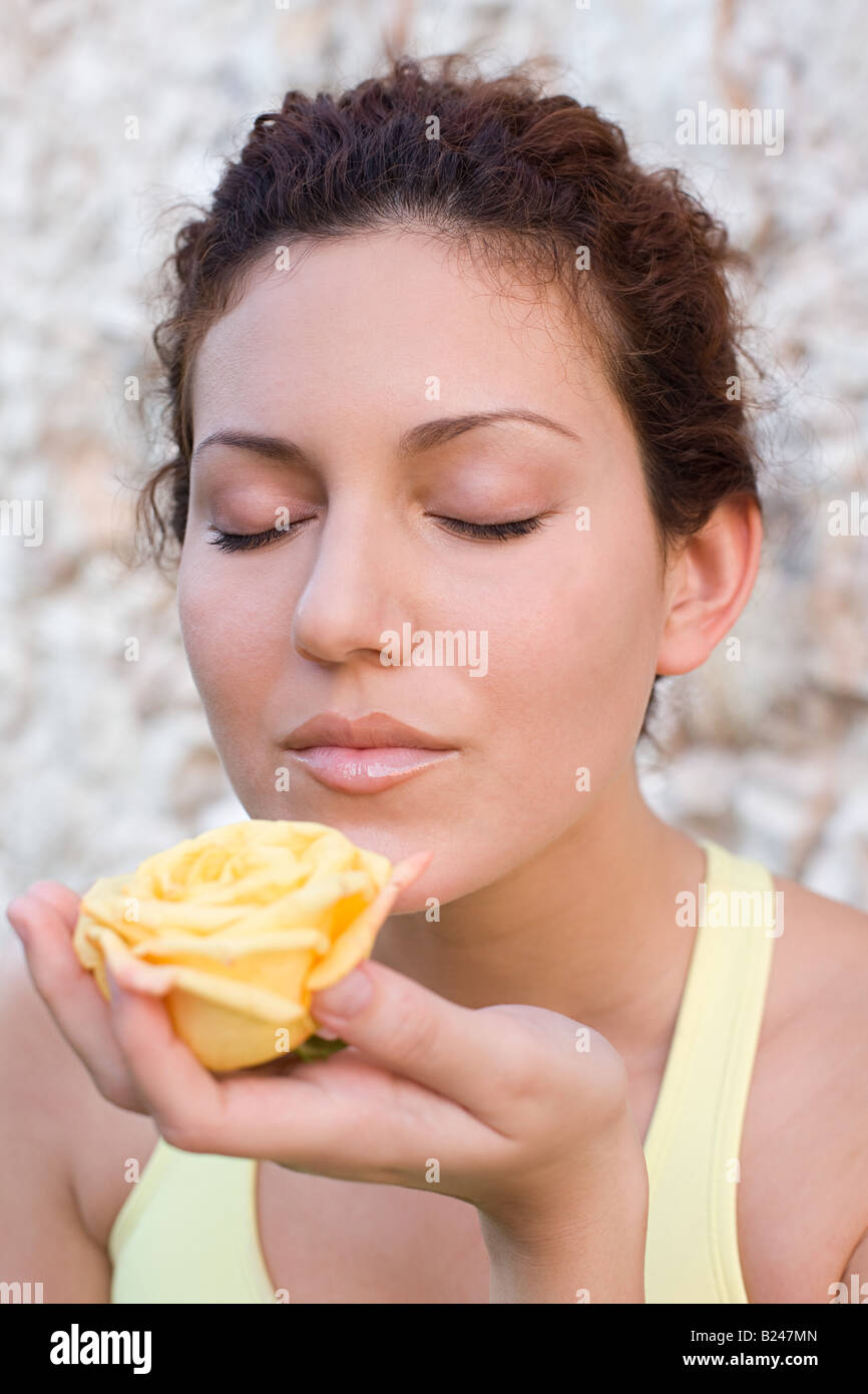 Woman smelling a rose Stock Photo - Alamy