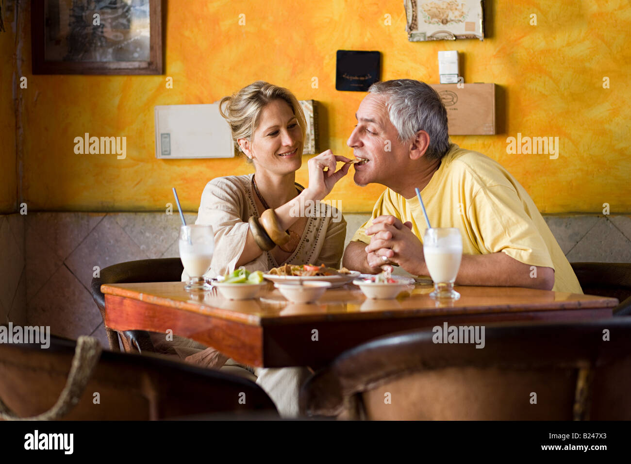 Couple eating in cafe Stock Photo - Alamy