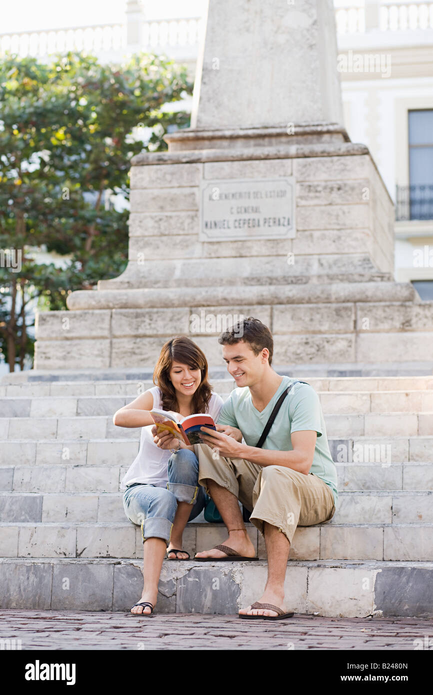 Couple with guidebook Stock Photo - Alamy