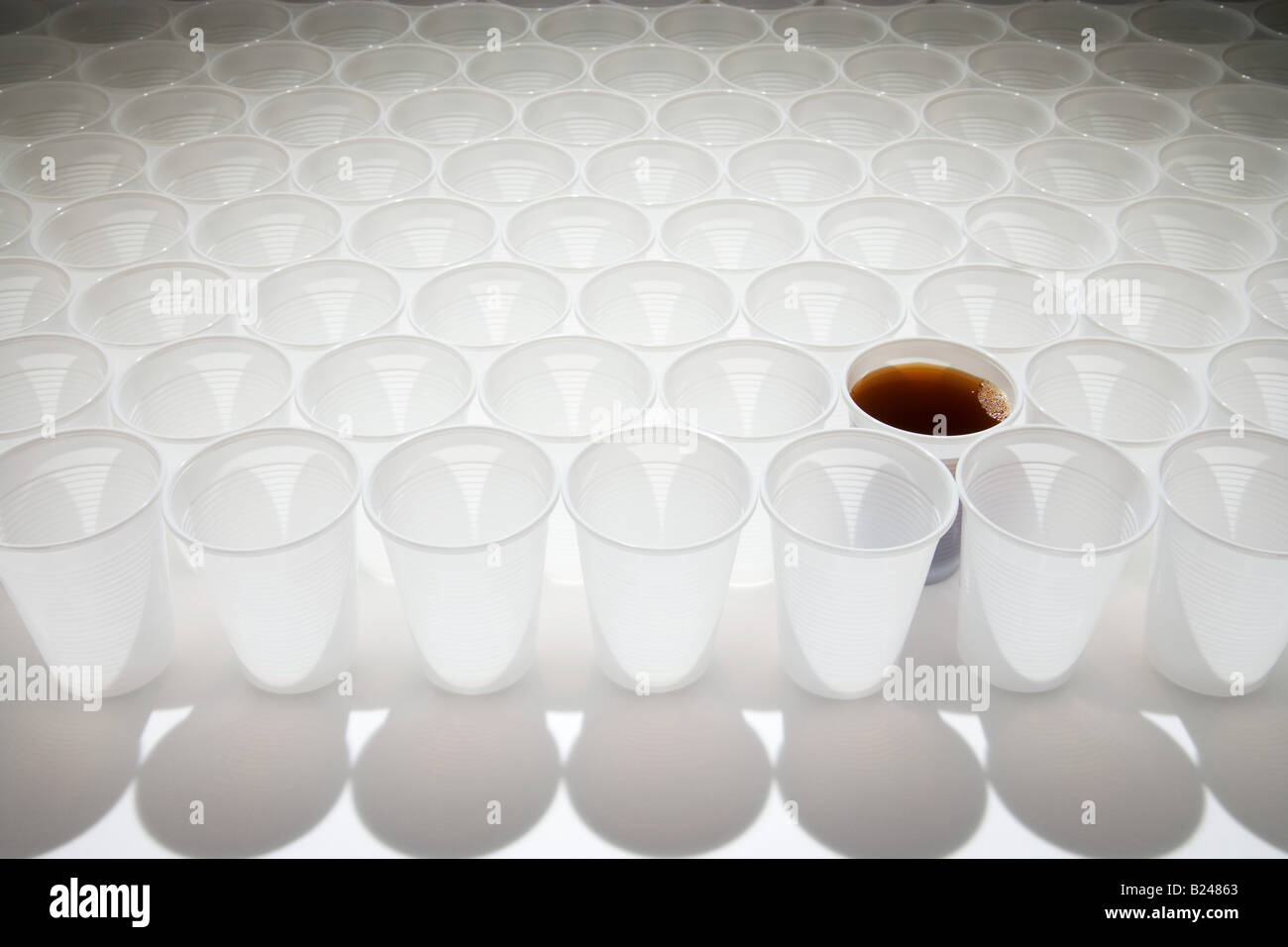 Cup of cola amongst empty cups Stock Photo - Alamy