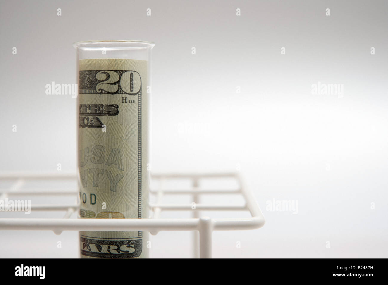 American banknote in a test tube Stock Photo - Alamy