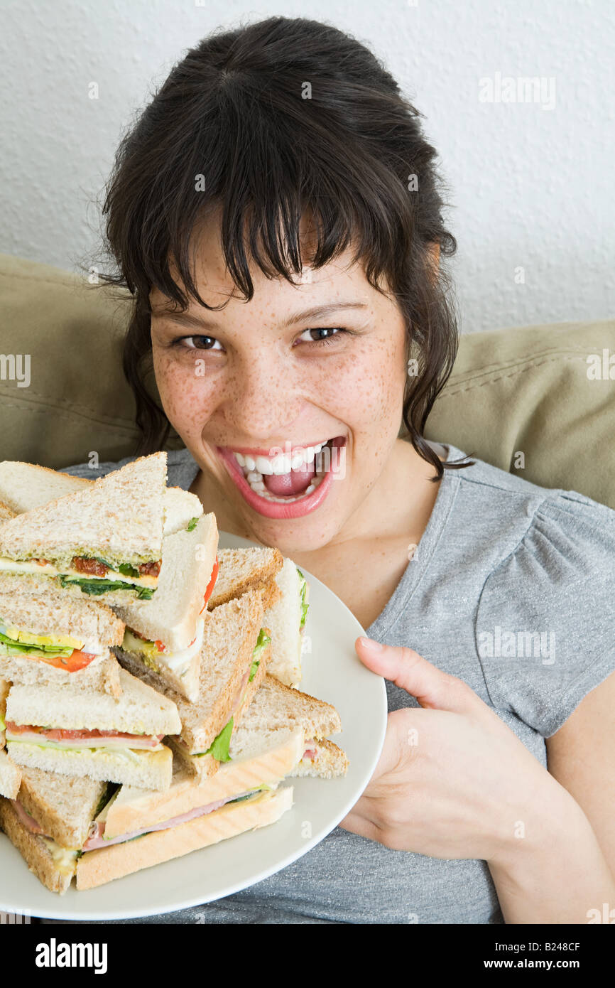 Woman with a stack of sandwiches Stock Photo - Alamy
