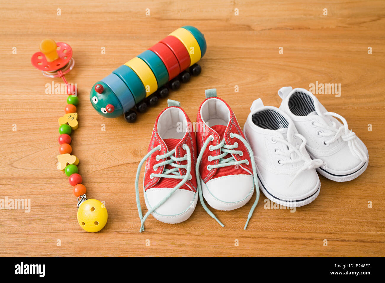 Baby shoes and toys Stock Photo - Alamy