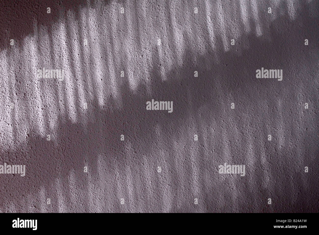 shadows of the sun through a shuttered window, reflected on a textured ...