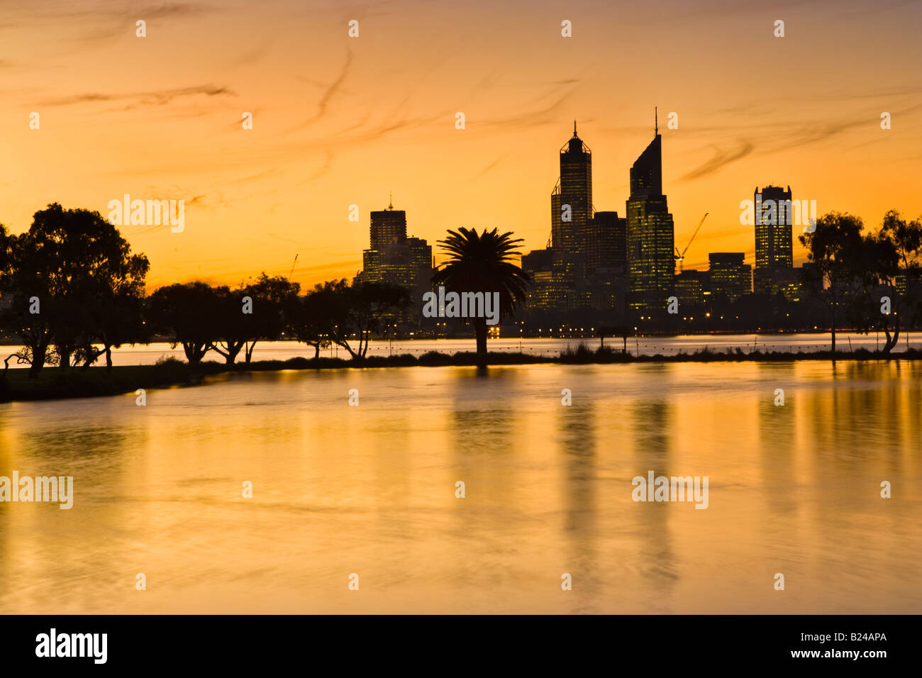 Perth's skyscrapers at sunset reflected in a lake on the South Perth ...