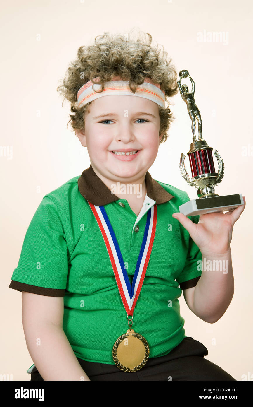 Portrait of a boy holding a trophy Stock Photo - Alamy