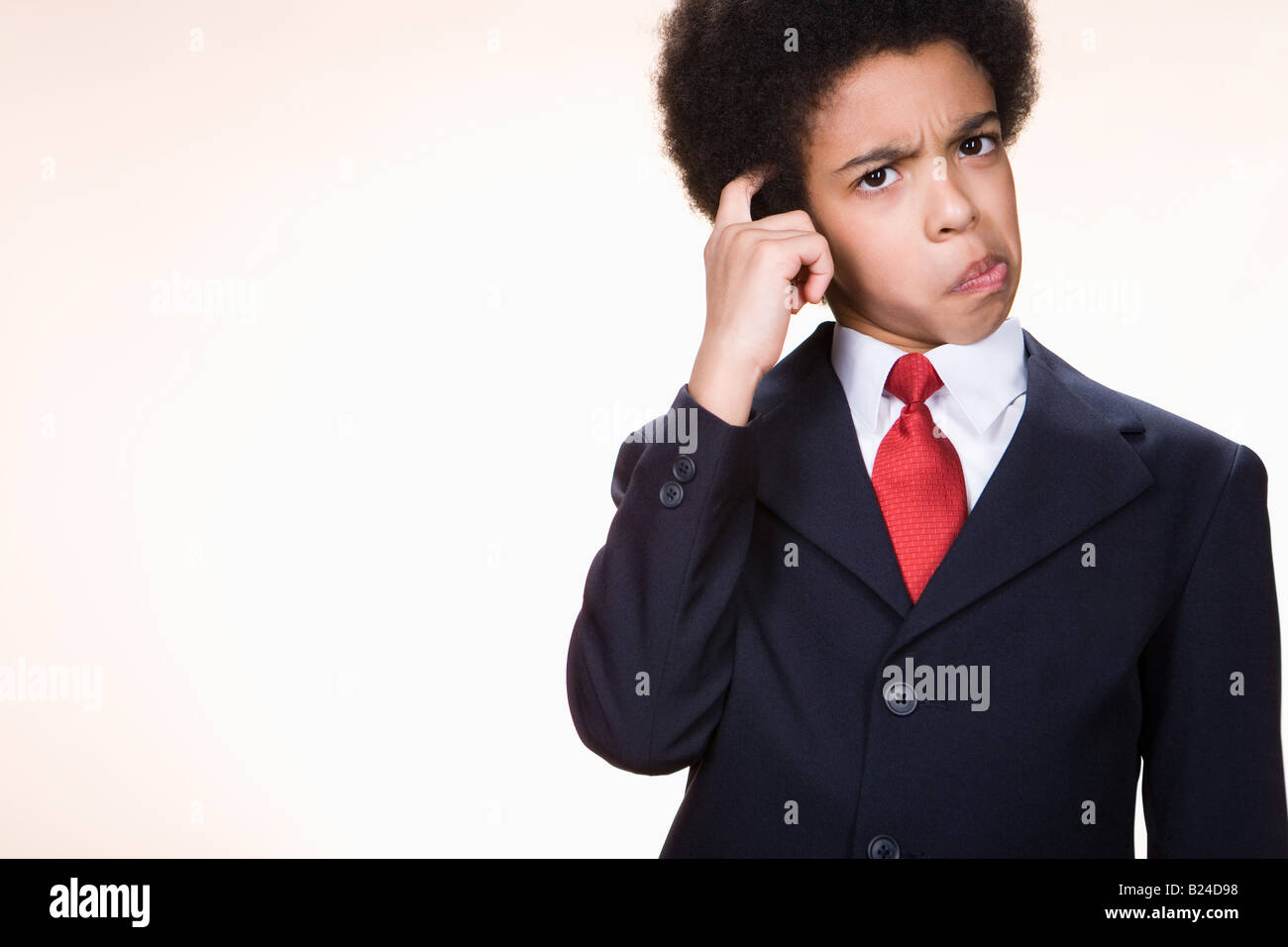A boy scratching his head Stock Photo - Alamy