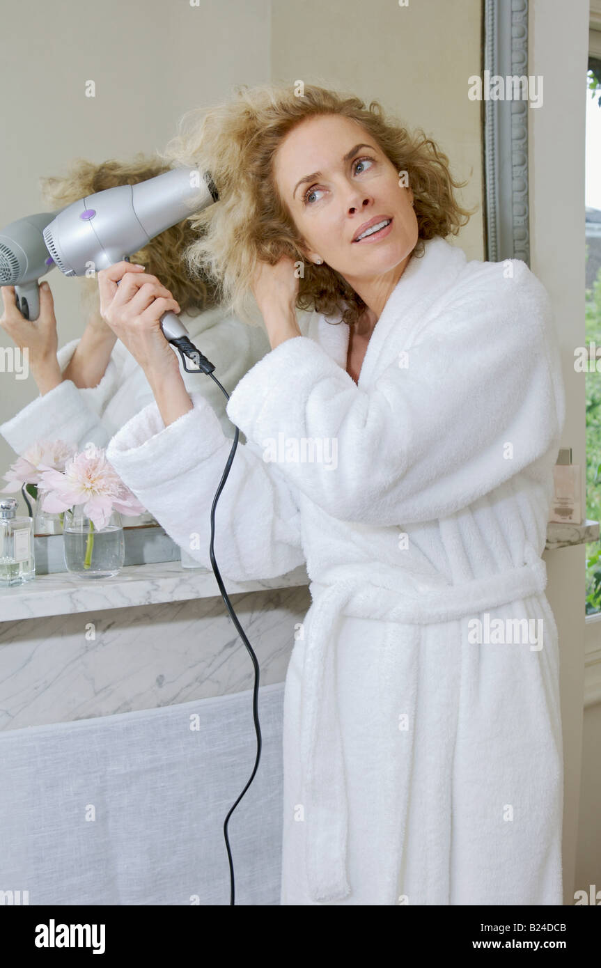 Woman with hair dryer hi-res stock photography and images - Alamy