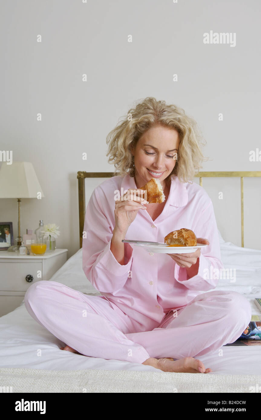 Woman having croissant Stock Photo - Alamy