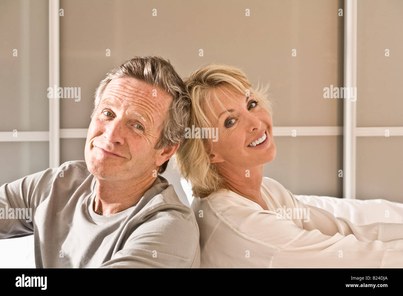 Couple back to back Stock Photo - Alamy