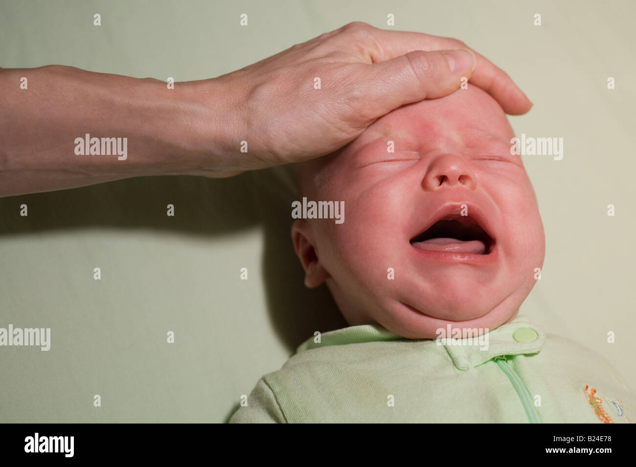 Person comforting crying baby Stock Photo - Alamy
