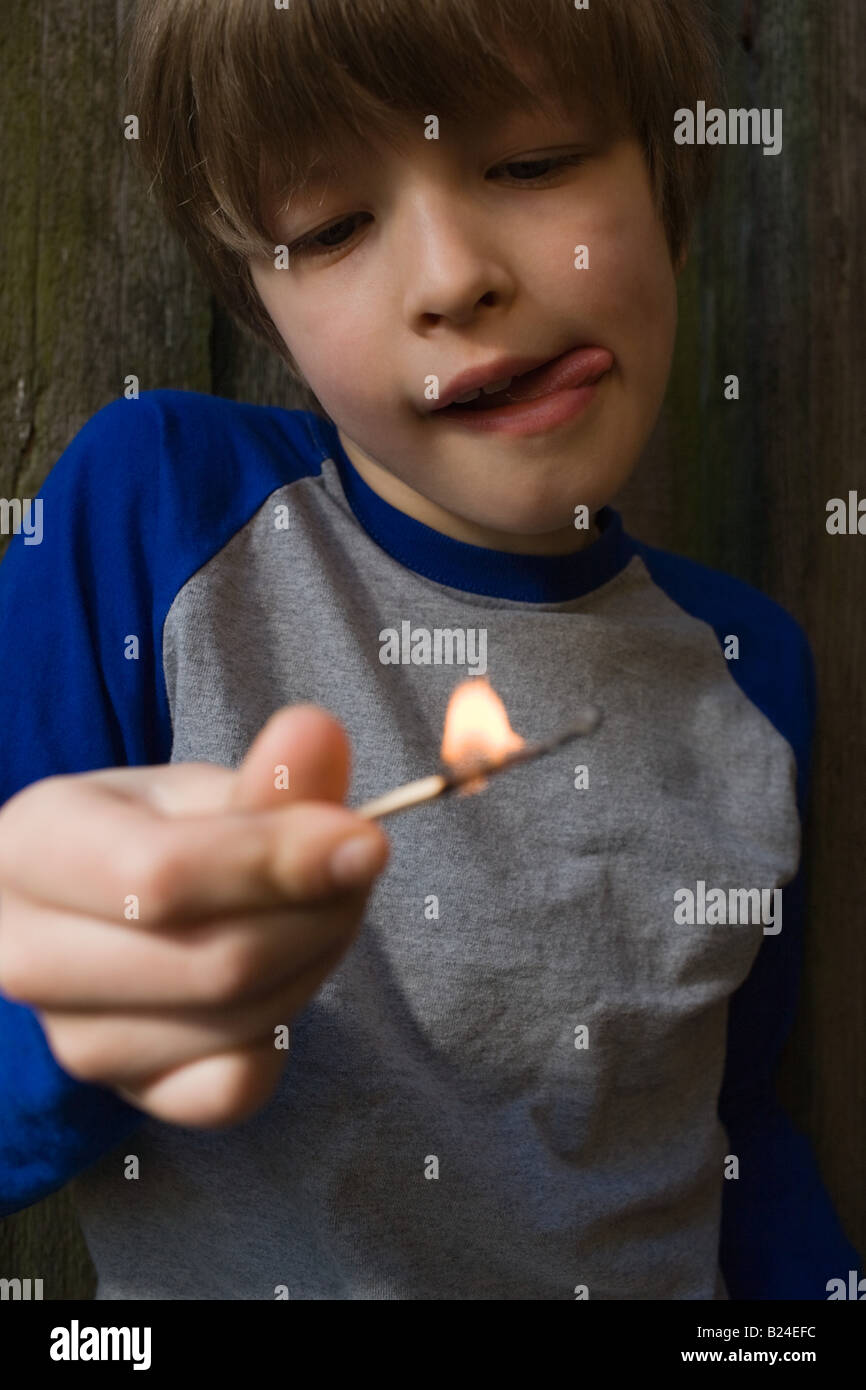Boy playing with fire Stock Photo - Alamy