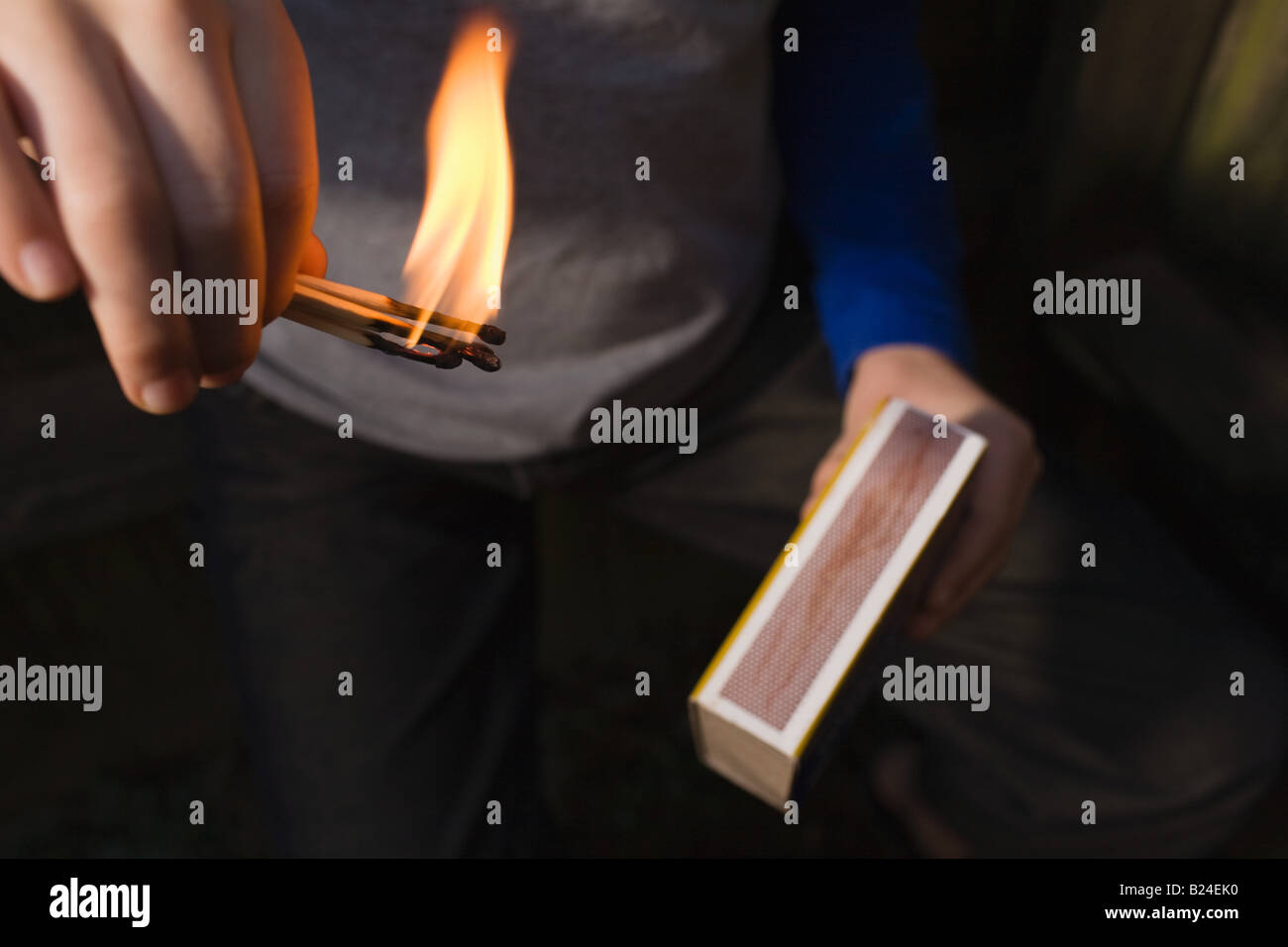Boy playing with fire Stock Photo - Alamy
