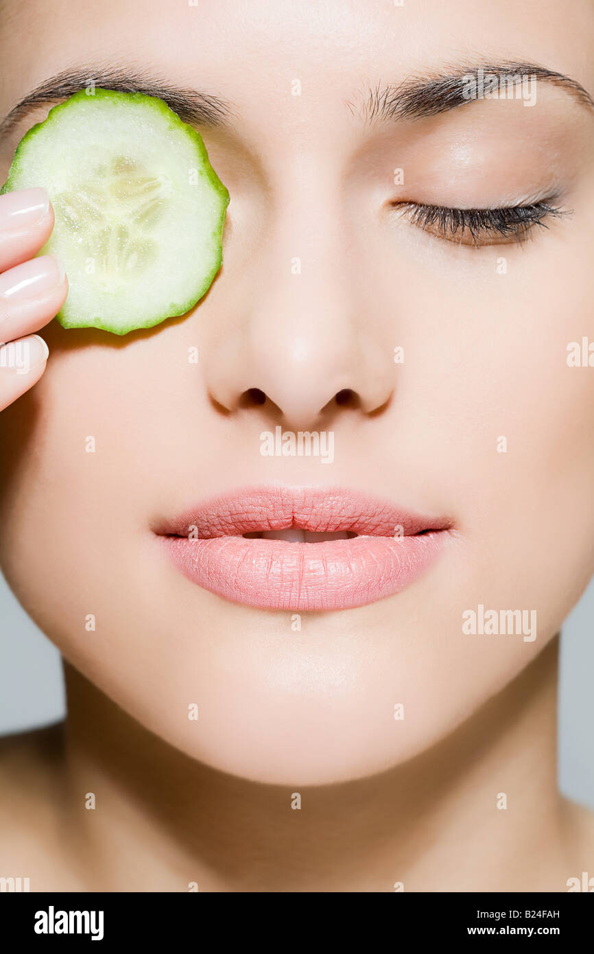 Woman with cucumber over her eye Stock Photo - Alamy