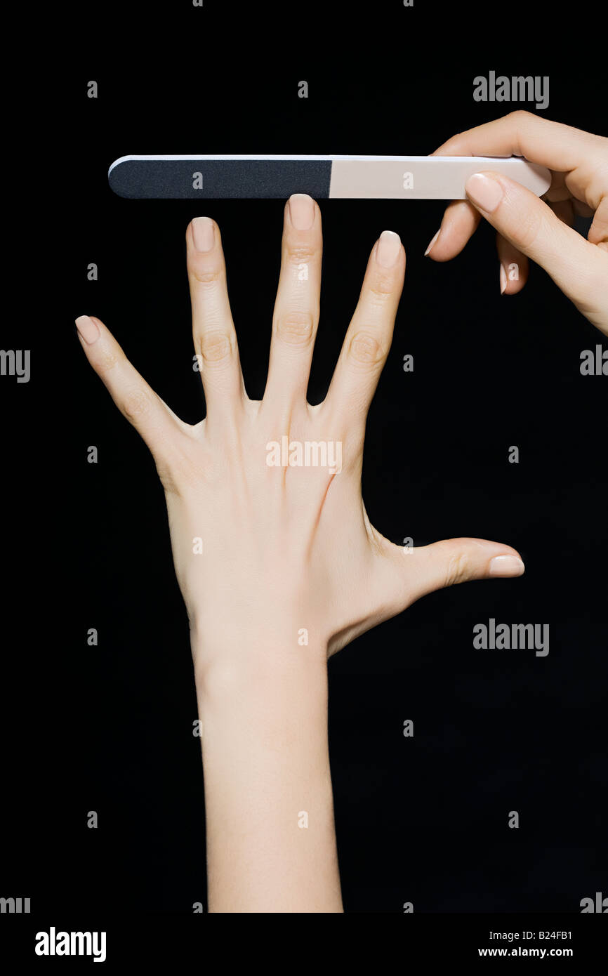 Woman filing her nails Stock Photo - Alamy