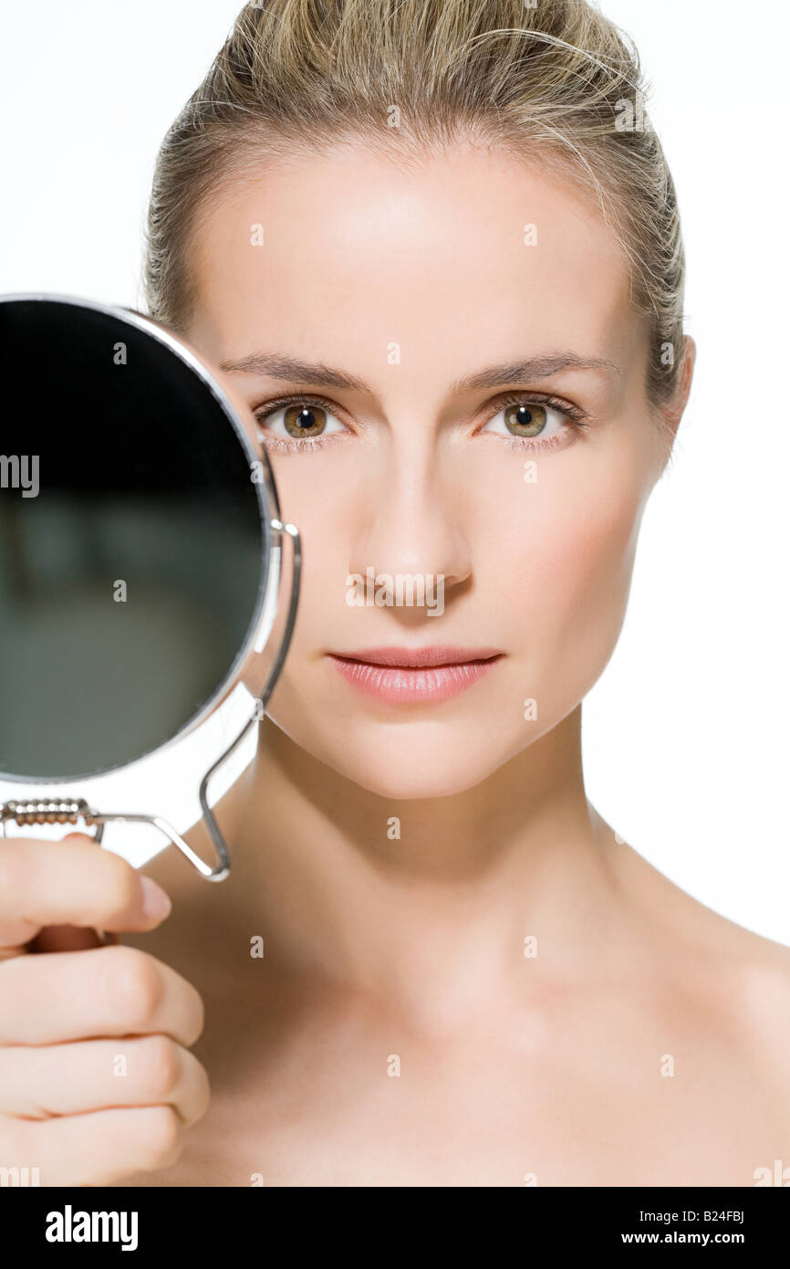 Woman holding mirror Stock Photo - Alamy