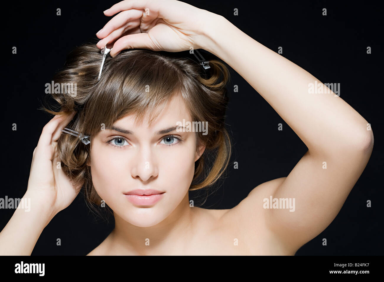 Woman styling her hair Stock Photo - Alamy