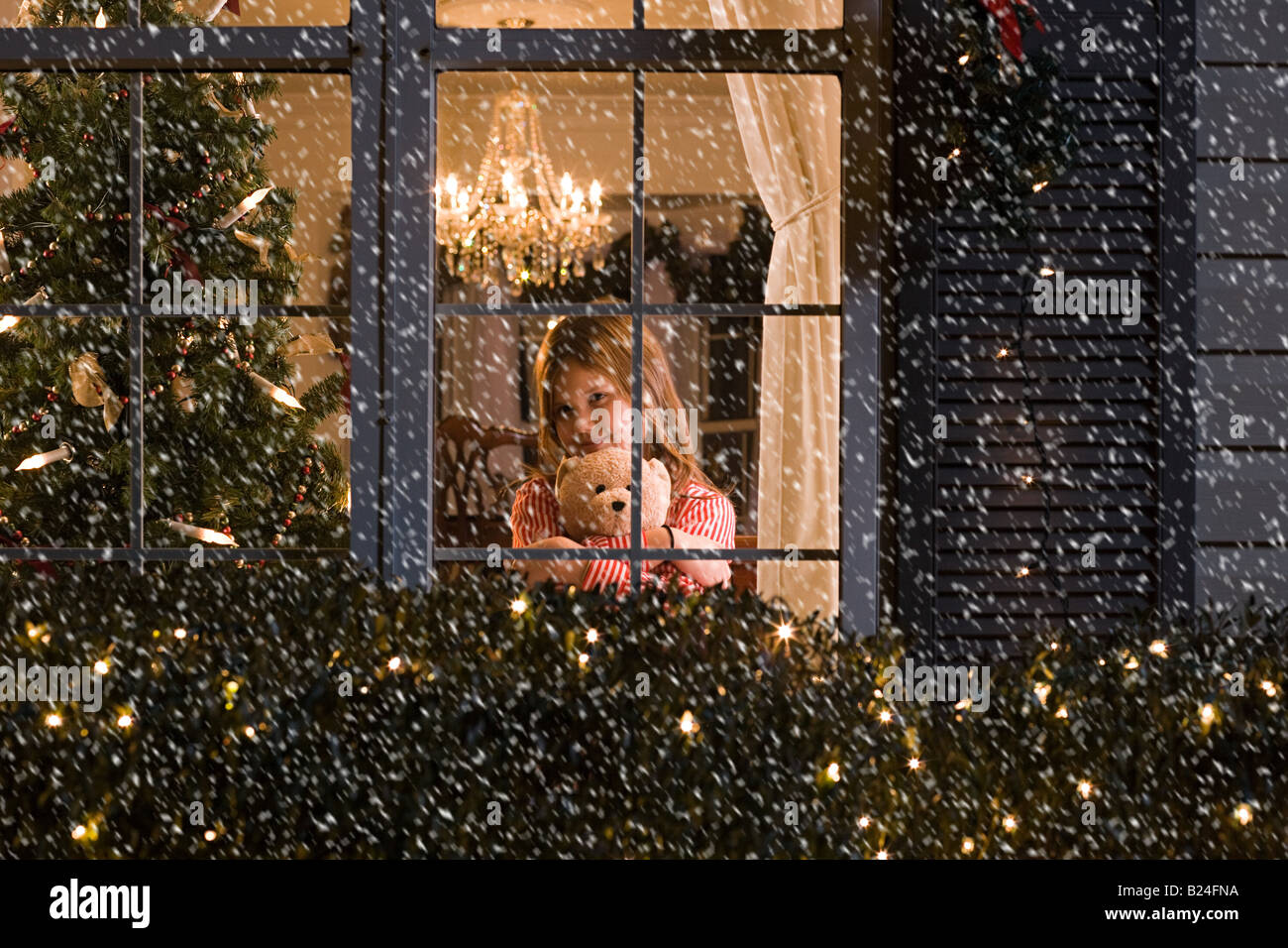 Girl looking at snow Stock Photo - Alamy